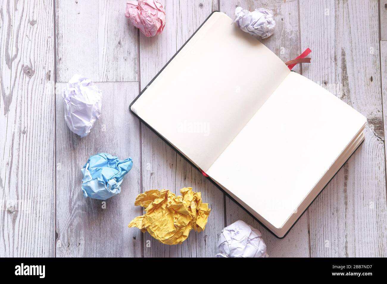 top view of crumpled paper ball and notepad on white background Stock ...