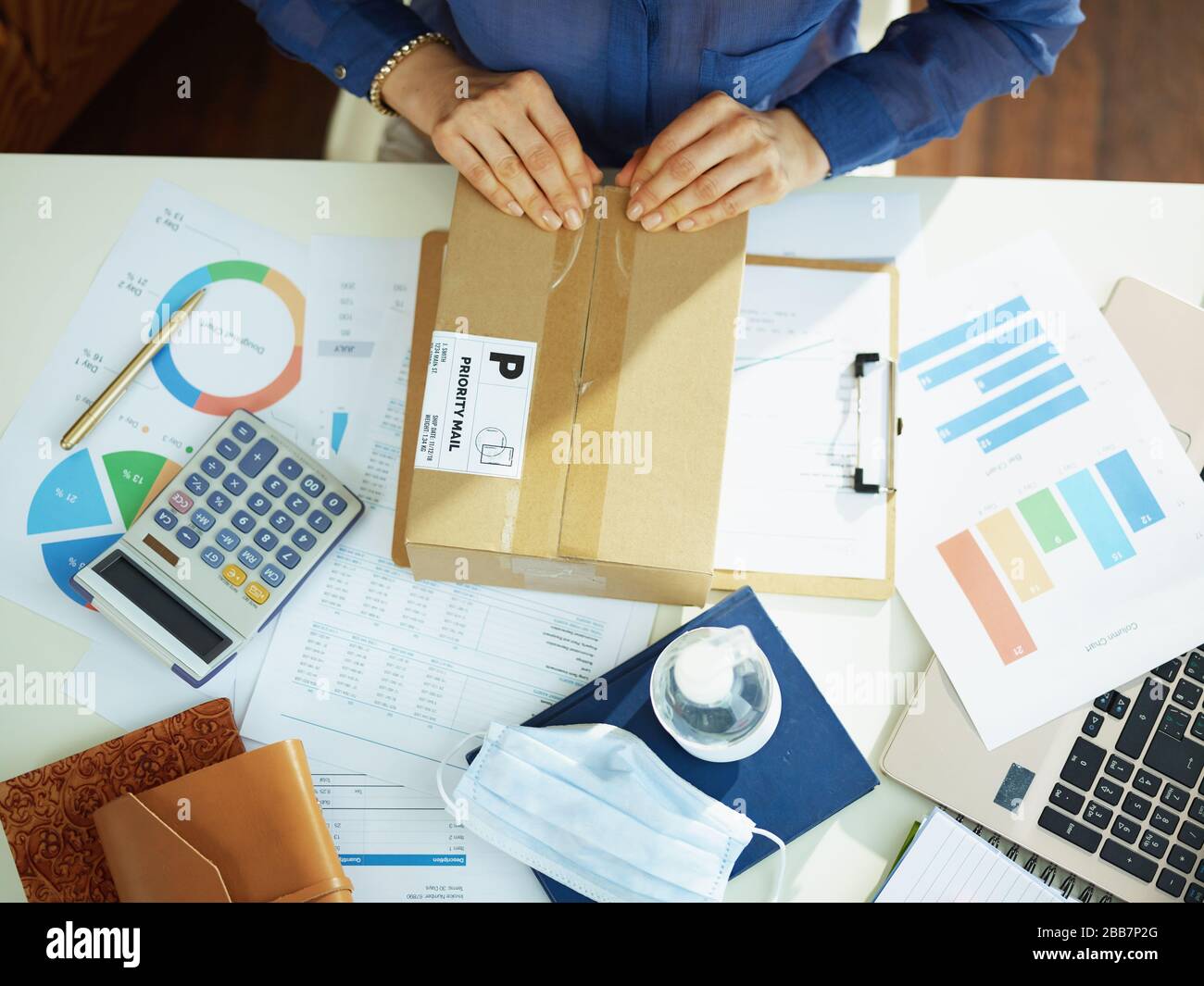 Upper view of business woman at the table opening parcel Stock Photo ...