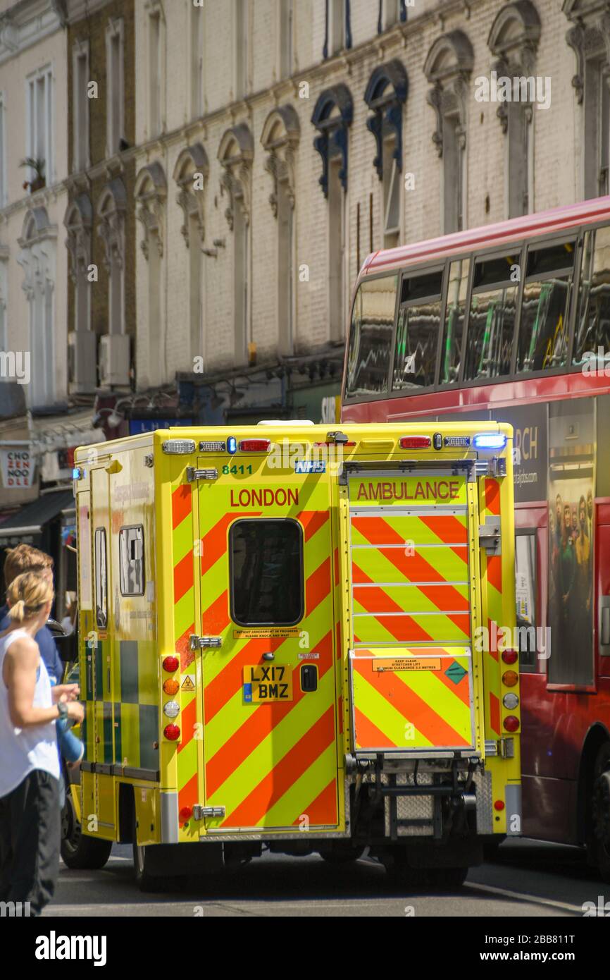 LONDON, ENGLAND - Ambulance on an emergency call driving through ...