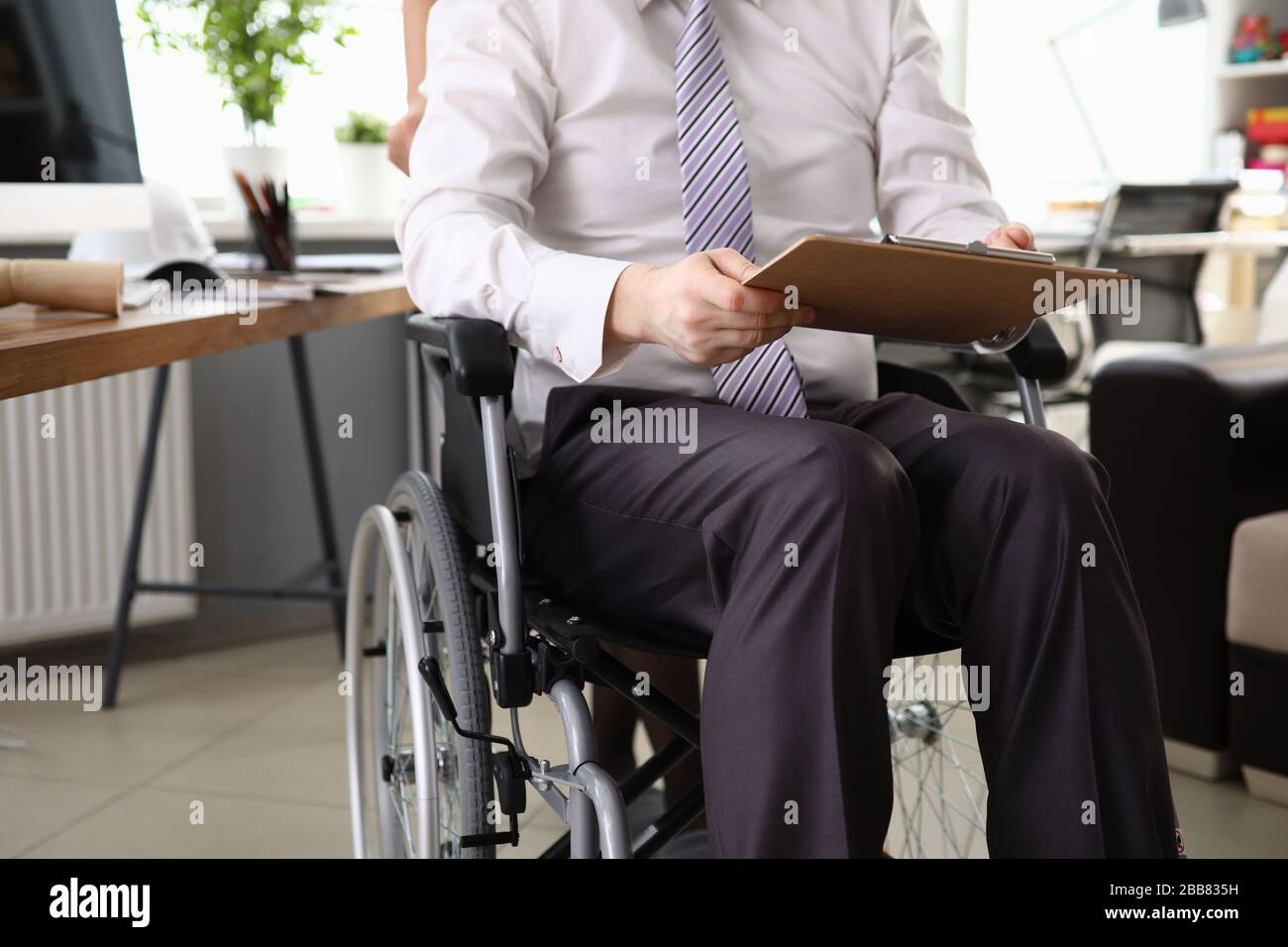 Employee man working in an office on wheelchair Stock Photo - Alamy