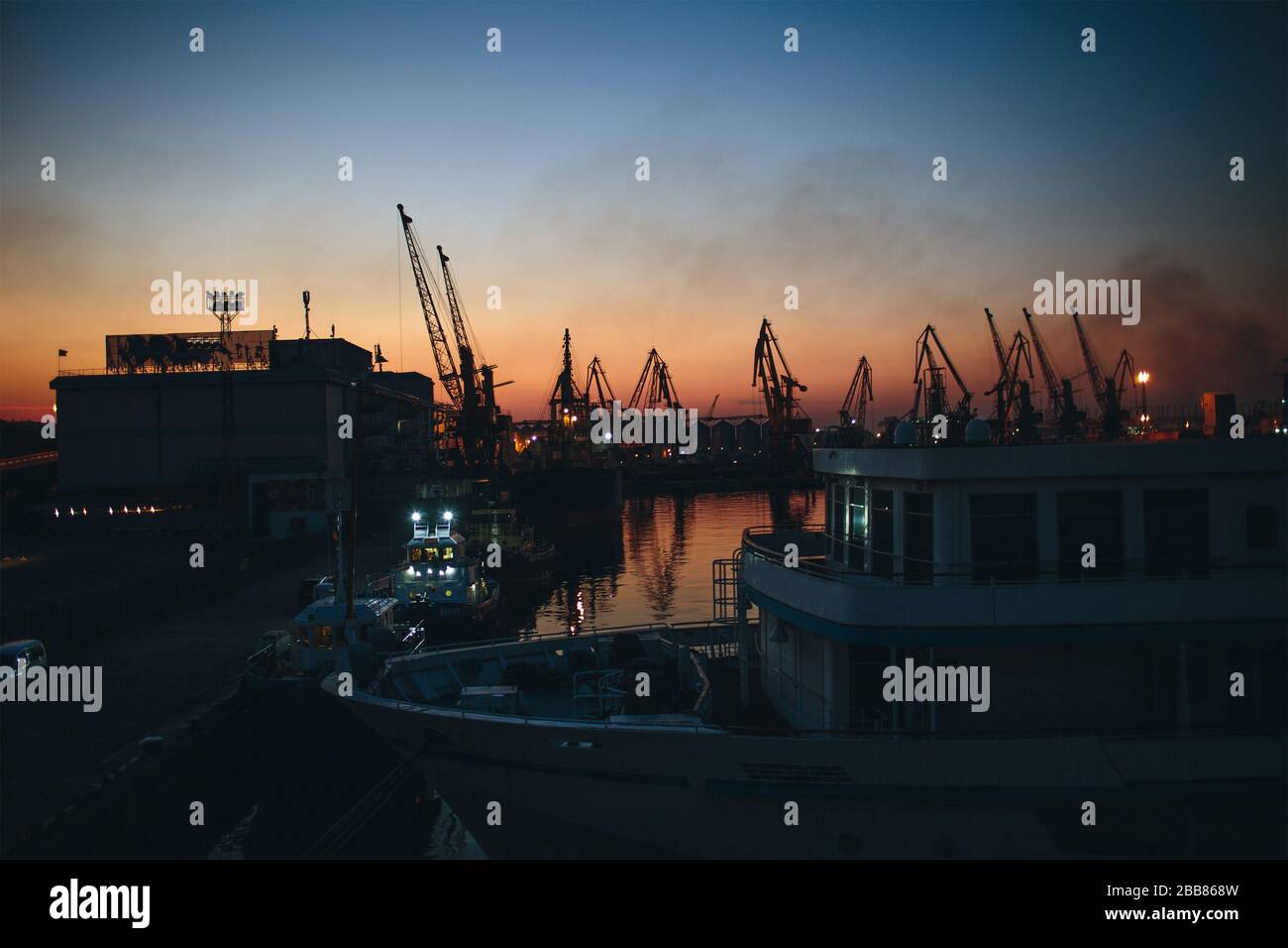 Old Shipping Port and old ship. Lights of night Stock Photo - Alamy