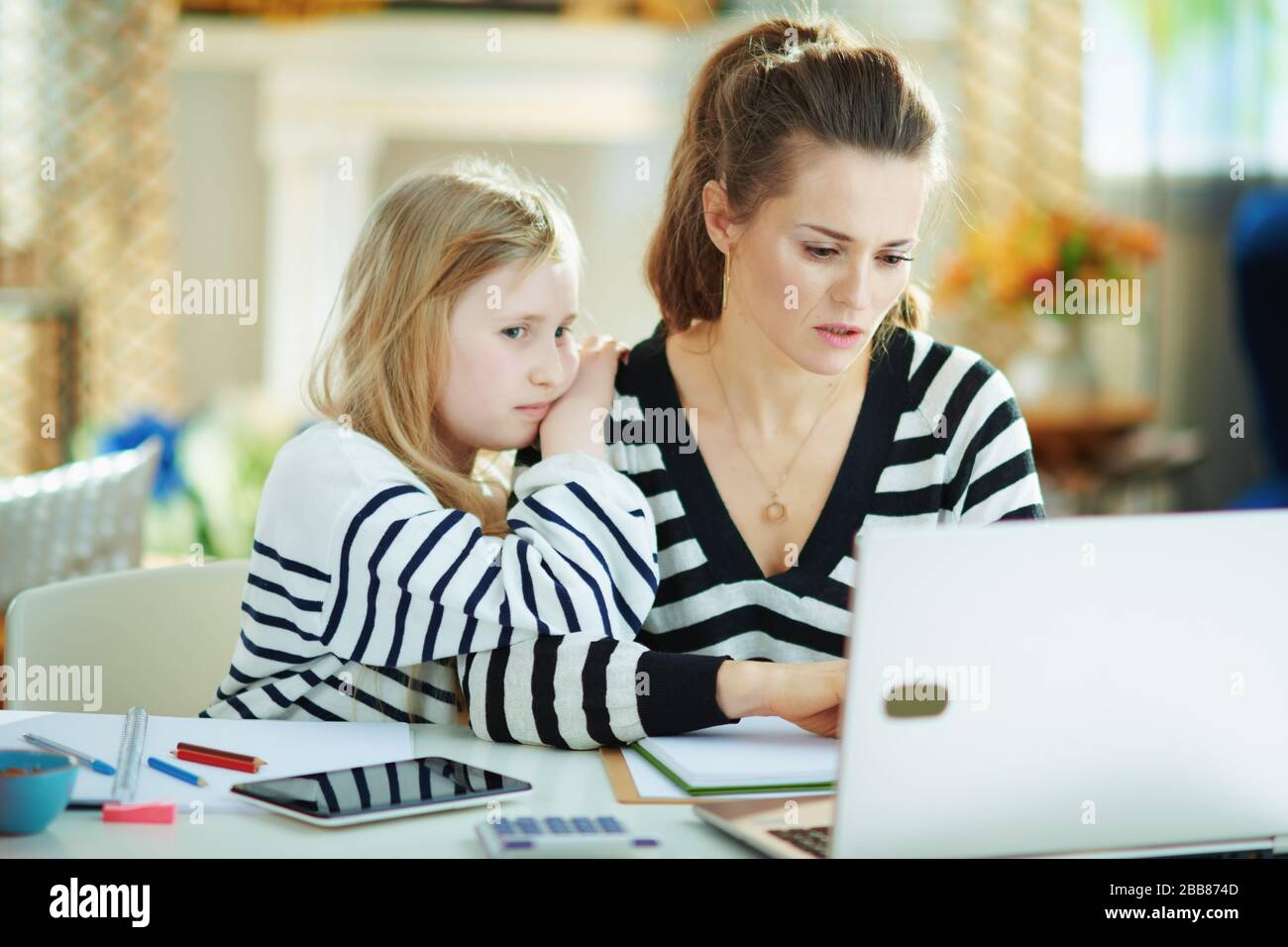 child craving attention while mother busy working in home office at ...