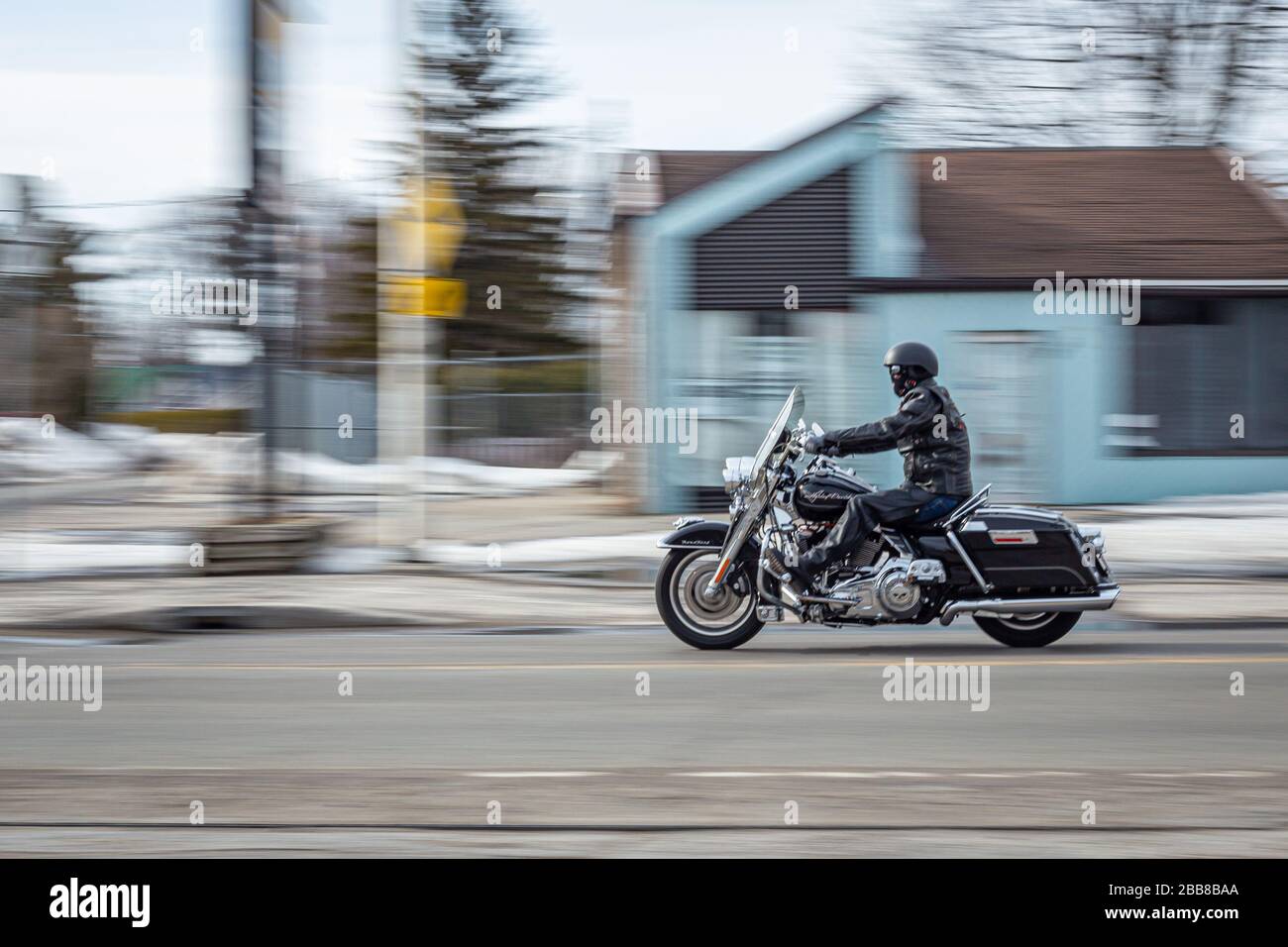 Motorcyclist Passing By Stock Photo - Alamy
