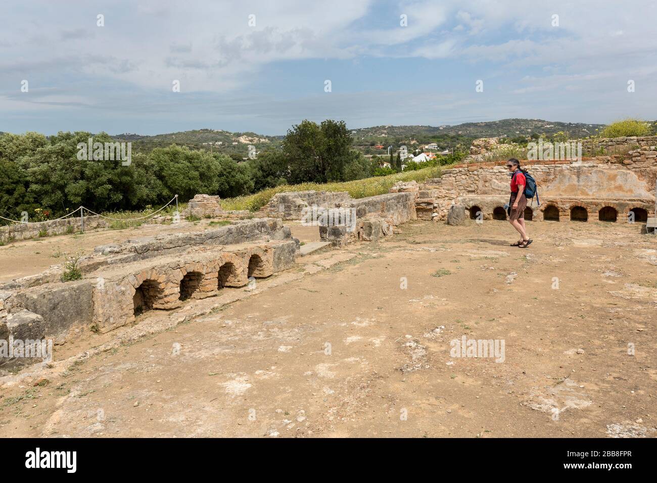 Visitor looking at the remains of the baths apodyterium at the 3rd ...