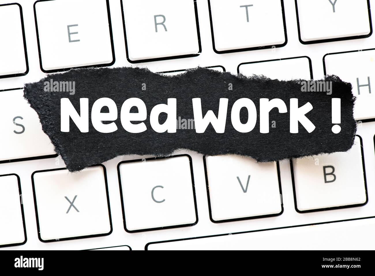 NEED WORK. Word need work written on a piece of black paper. Economic ...