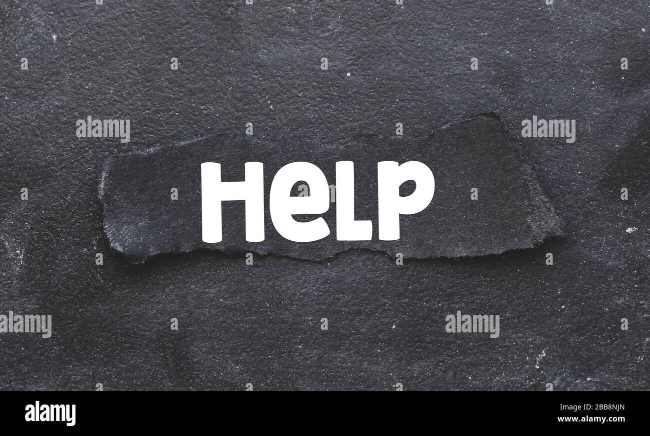 HELP. Word HELP written on a piece of black paper. Economic crisis ...