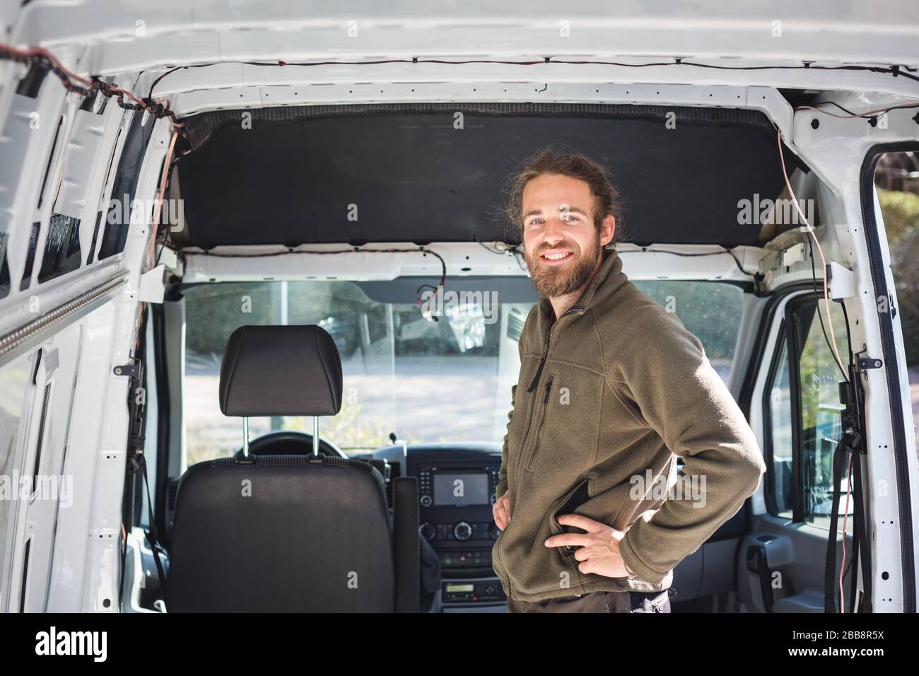 Smiling man inside his camper van Stock Photo - Alamy