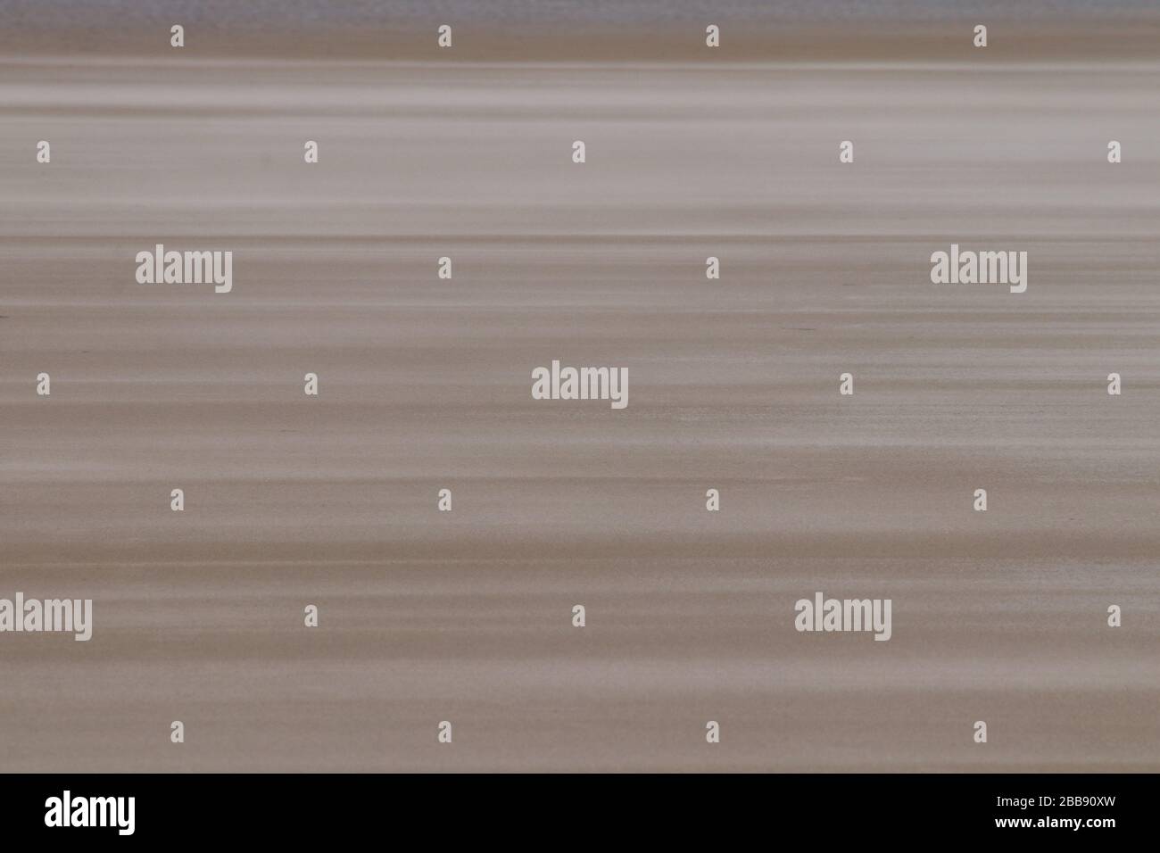 Wind-driven sand by sea Stock Photo - Alamy