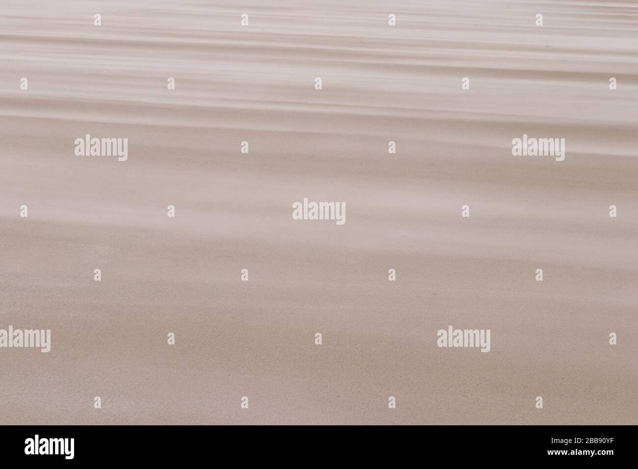 Wind-driven sand by sea Stock Photo - Alamy