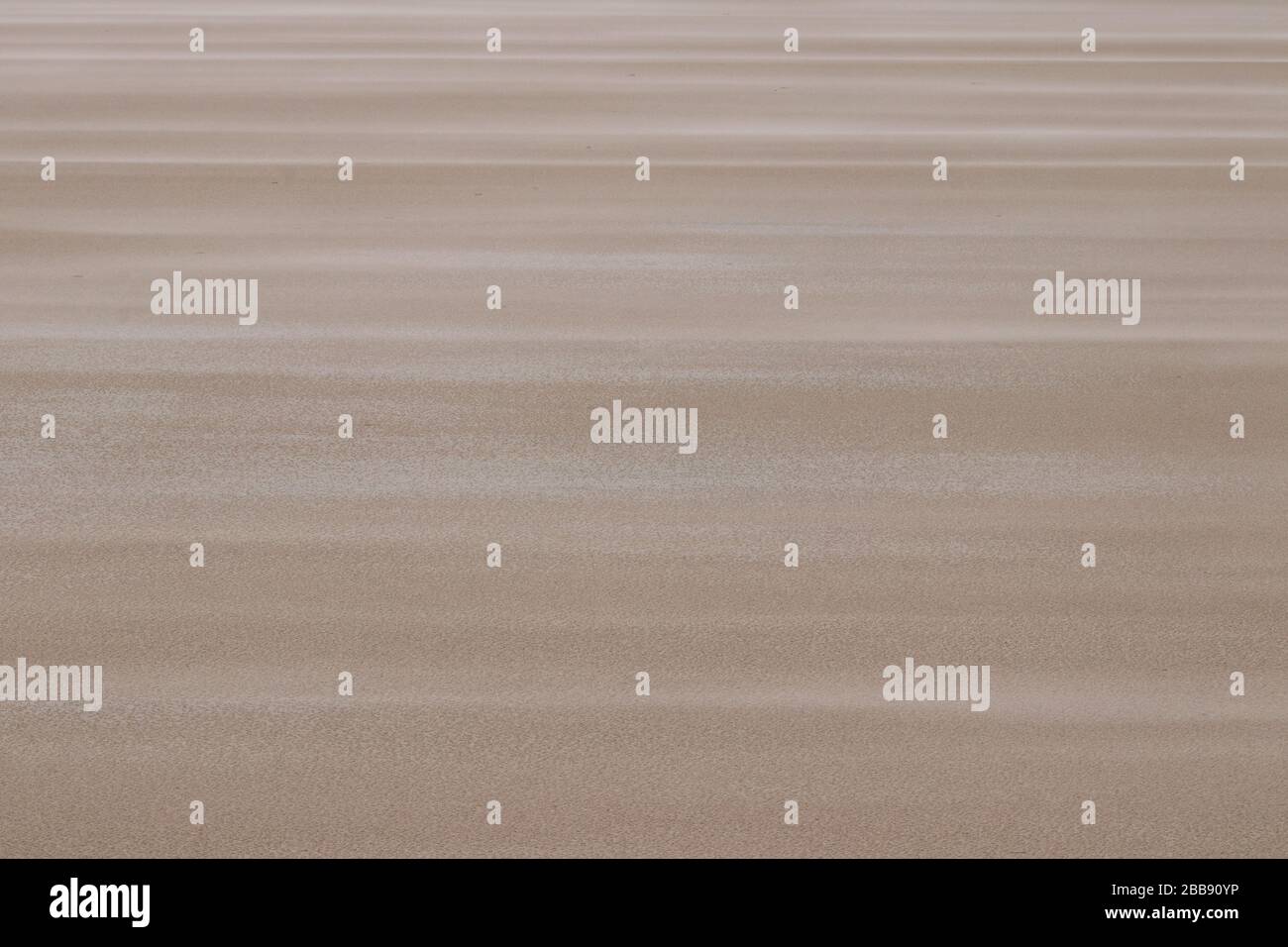 Wind-driven sand by sea Stock Photo - Alamy