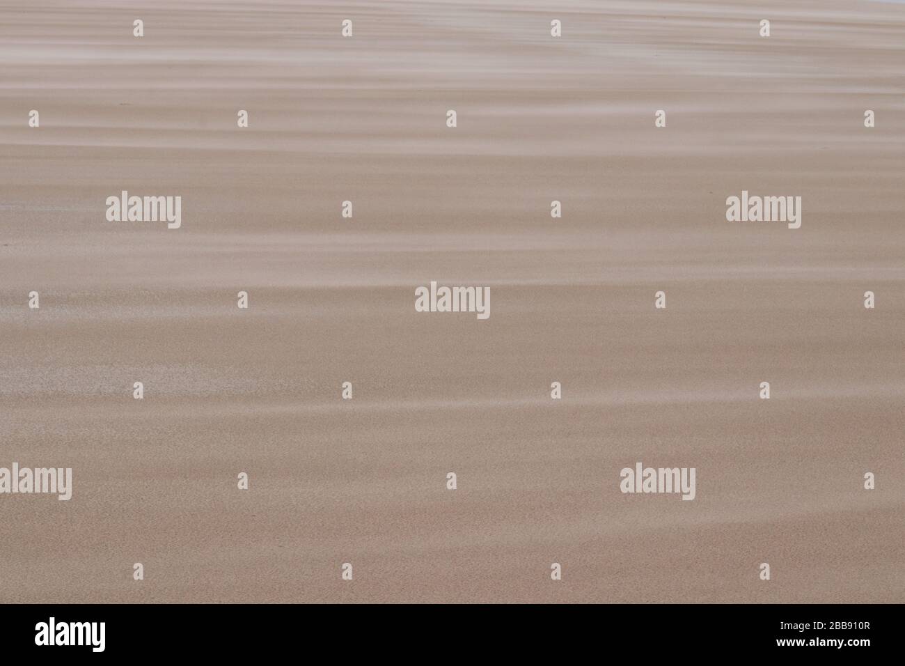 Wind-driven sand by sea Stock Photo - Alamy