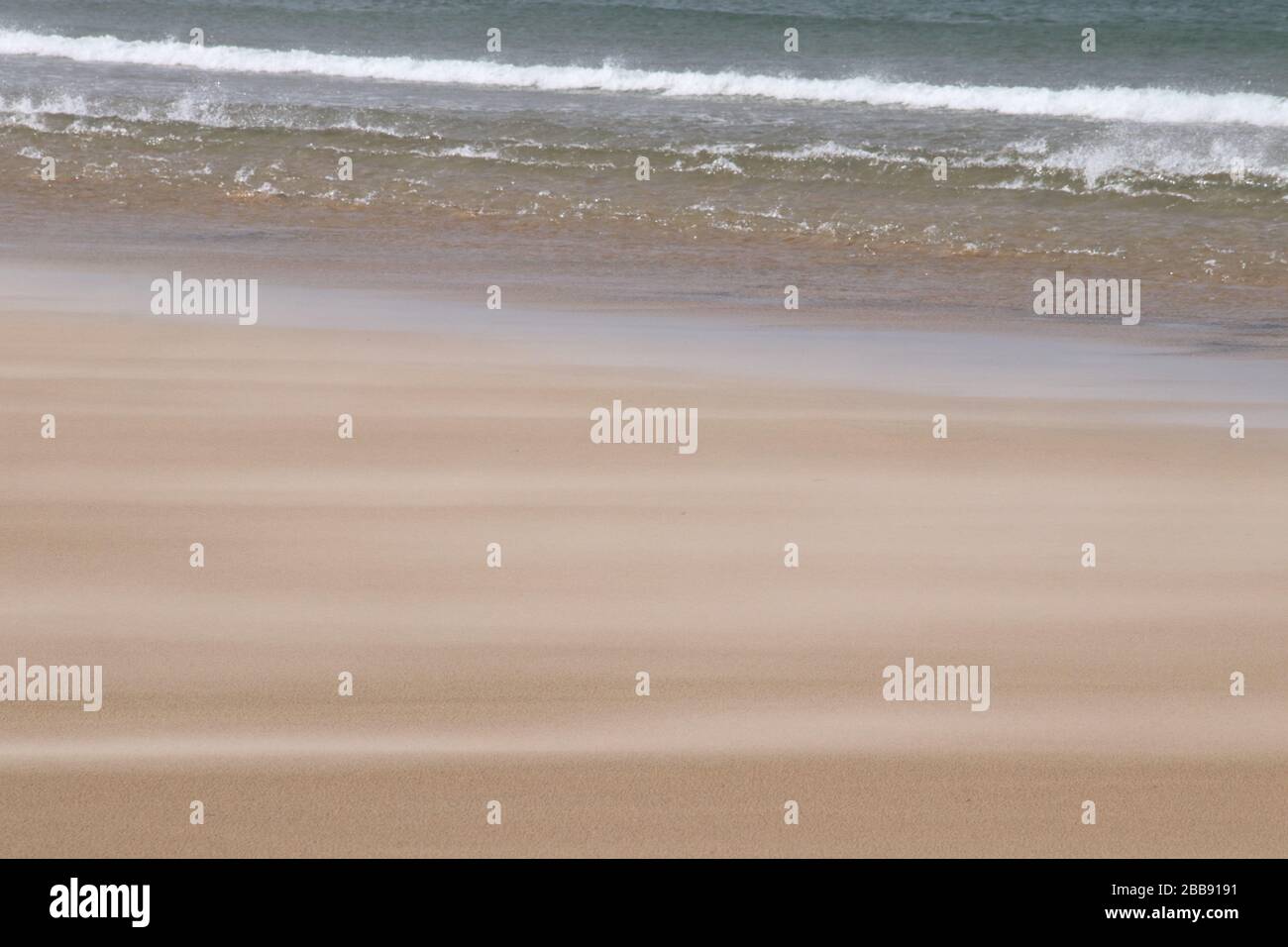 Wind-driven sand by sea Stock Photo - Alamy