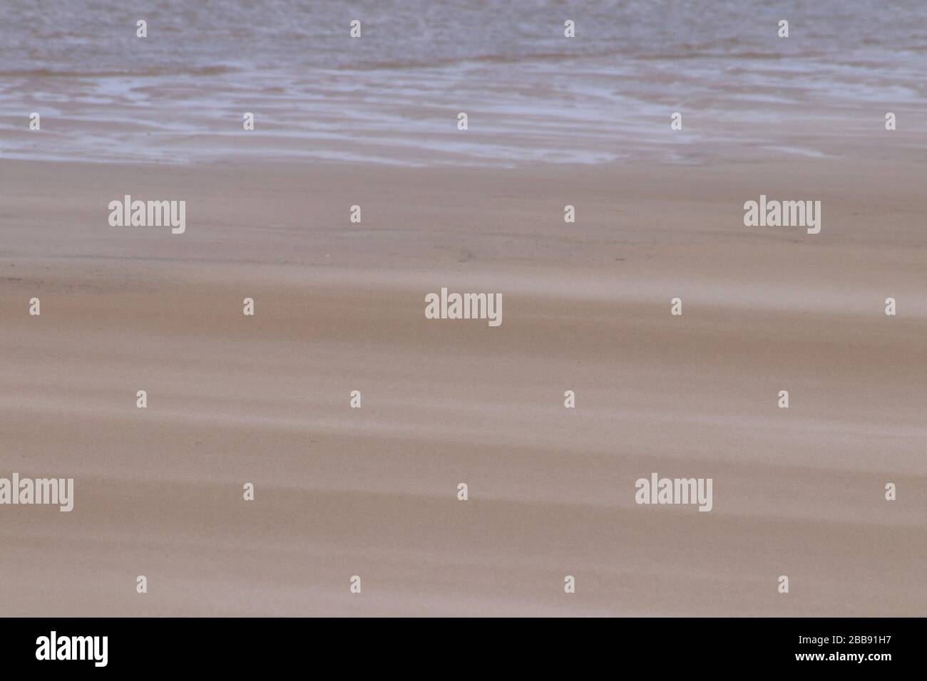 Wind-driven sand by sea Stock Photo - Alamy