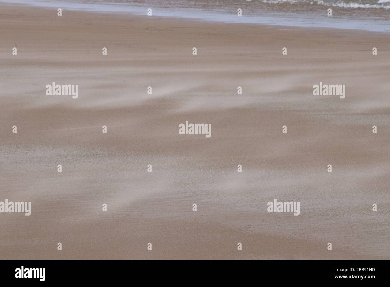Wind-driven sand by sea Stock Photo - Alamy