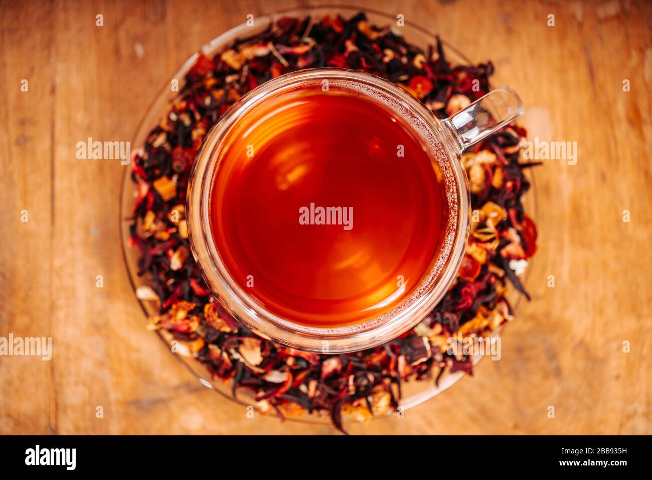 Cup of hot tea with rock sugar, dry tea leaves served in thermo glass ...