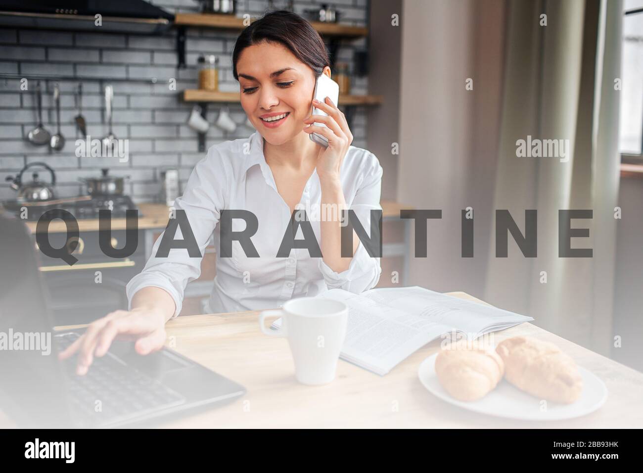 Nice cheerful woman sit at table and work at home. She typing on laptop ...
