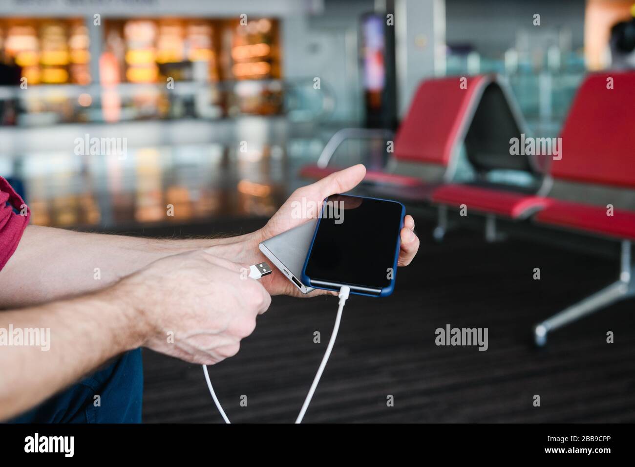 Hands connect power bank cable to smartphone Stock Photo - Alamy
