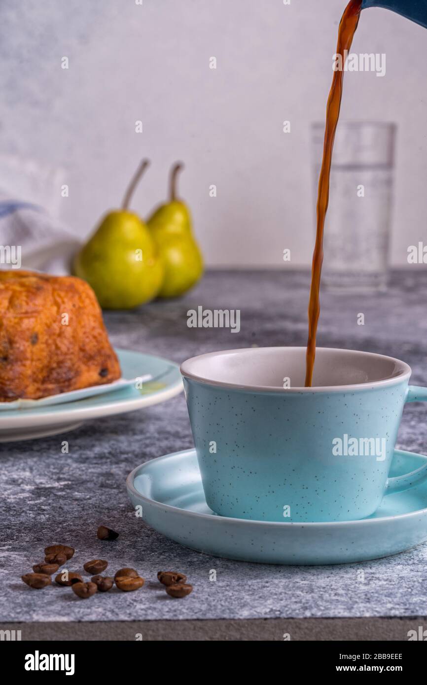 Pouring black coffee in to the Cup , blurred bokeh background, morning ...