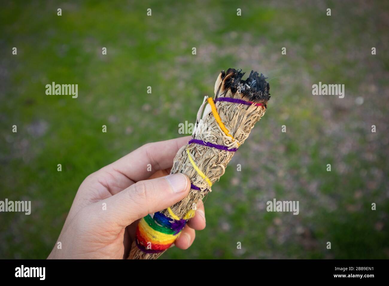 Hand Holding Sage performing Smudging Ritual Stock Photo - Alamy