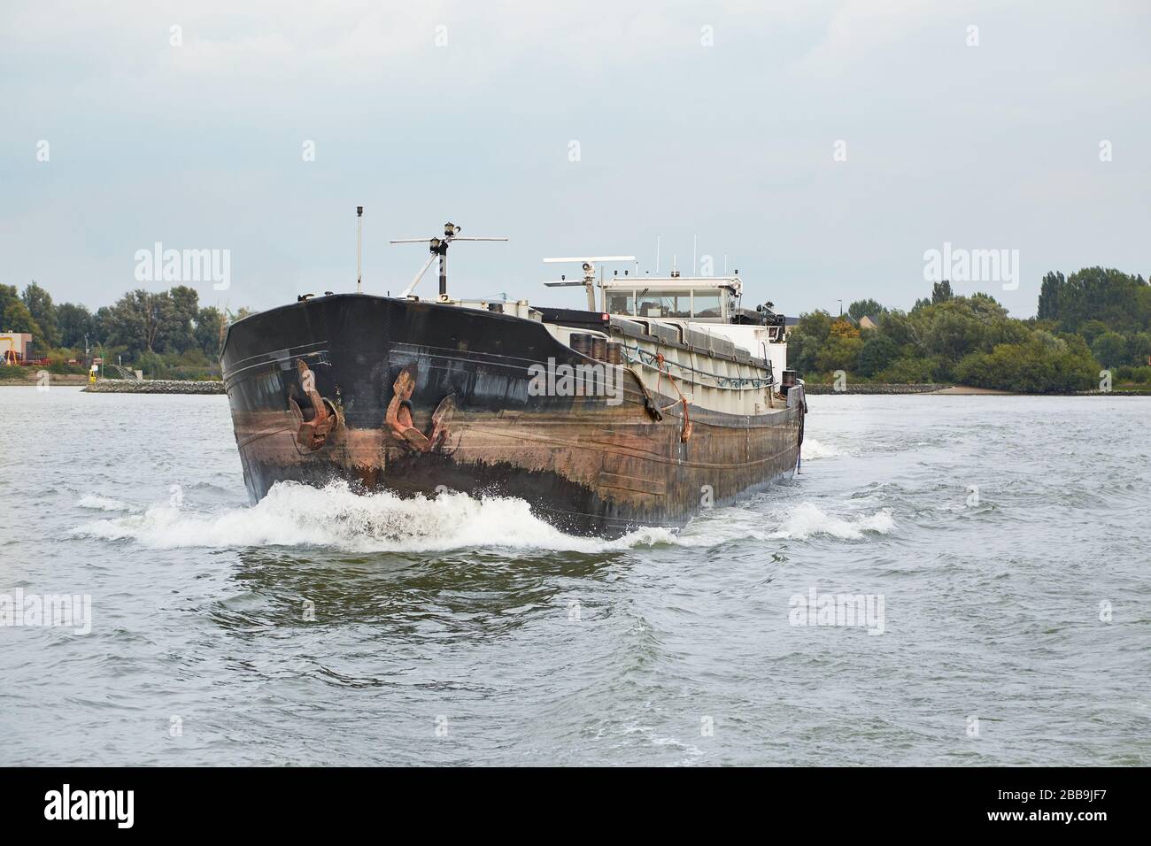 Ship carrying cargo on a river Stock Photo - Alamy