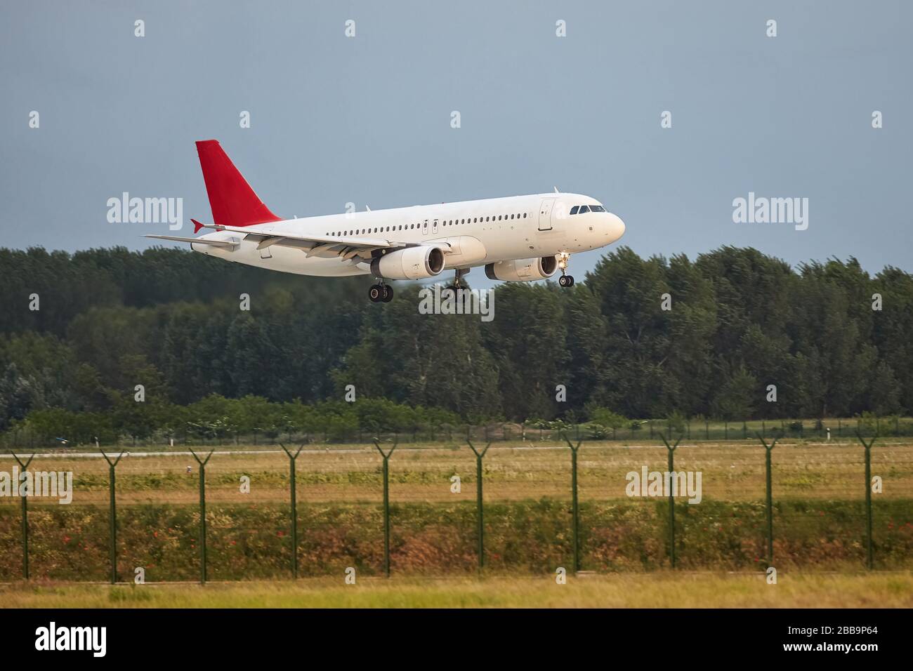 Plane landing on runway Stock Photo - Alamy