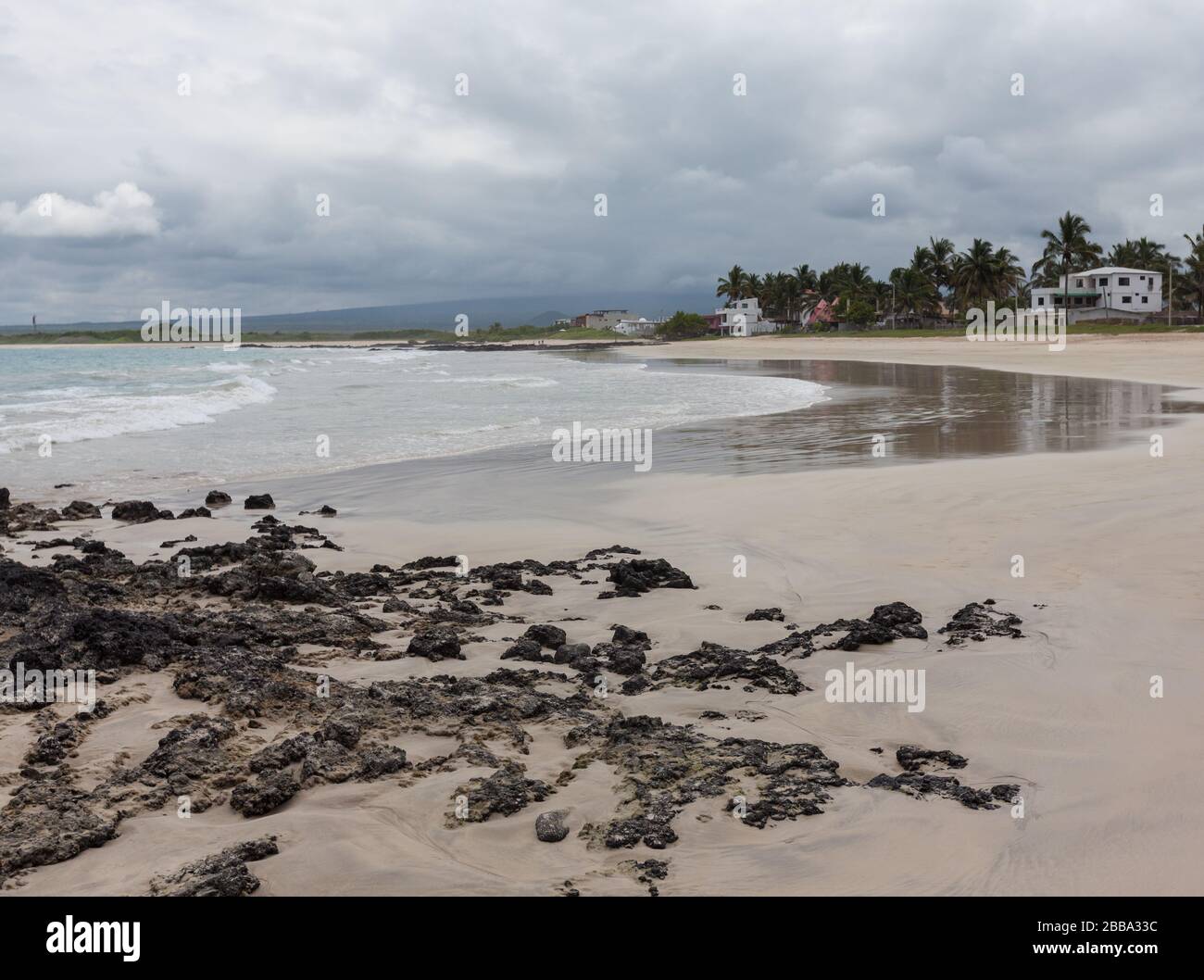 Cloudy dramatic sky over Puerto Villamil on Isabela island empty bay ...