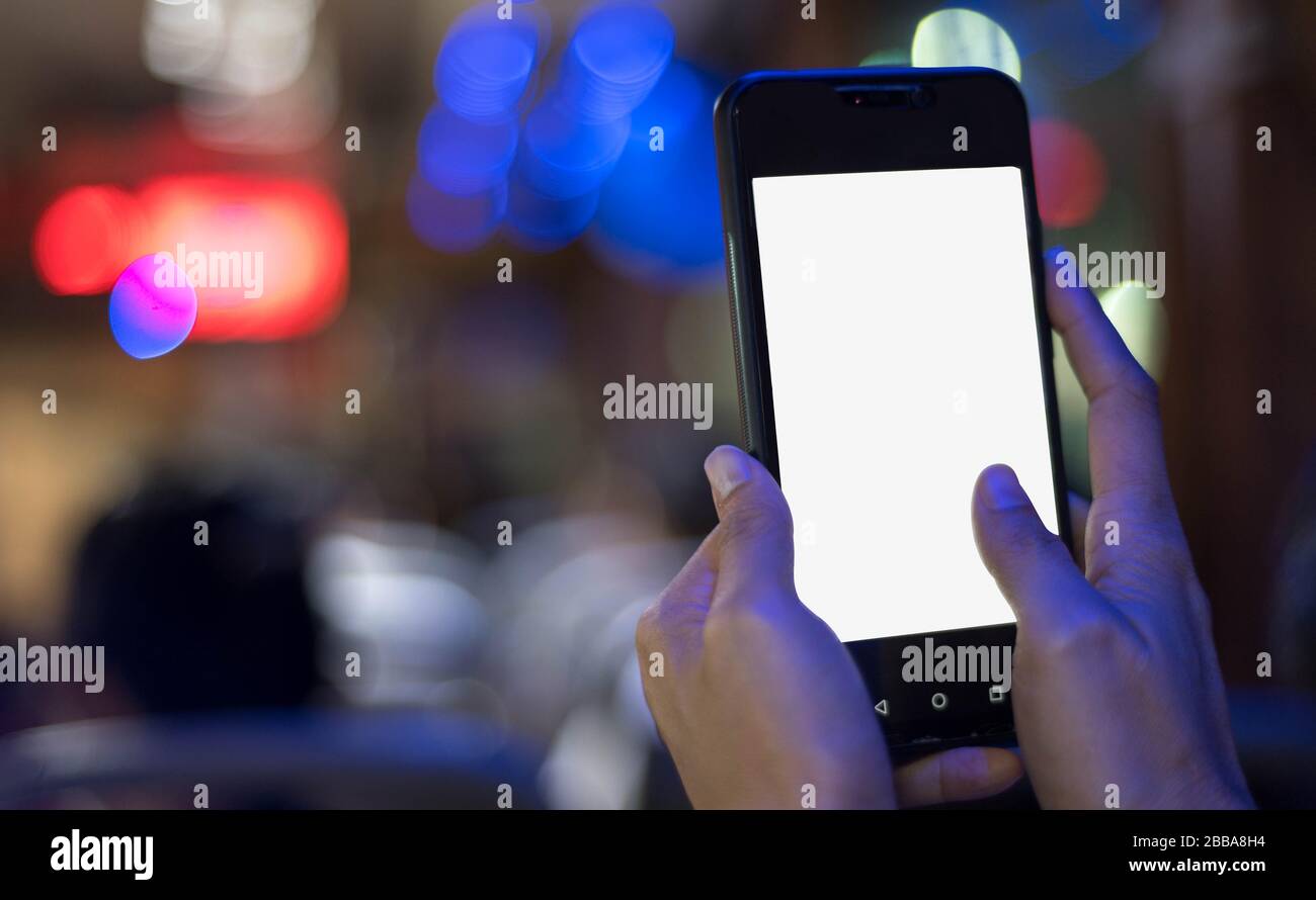 Woman hands holding smart phone with blank blank screen for text ...