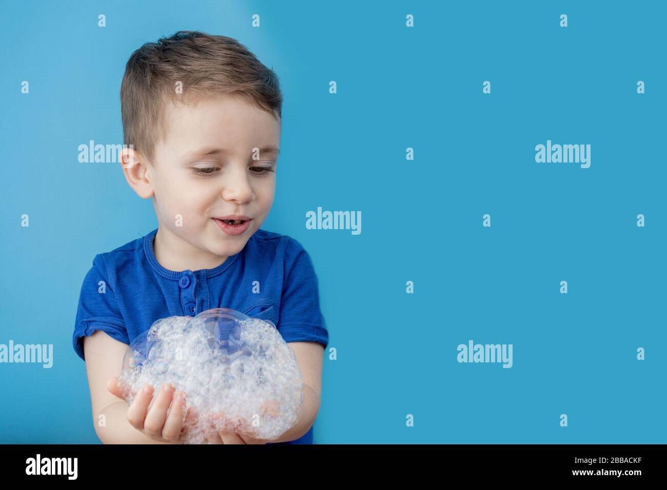 Child showing his hands with soap lather, cleaning and hygiene concept ...