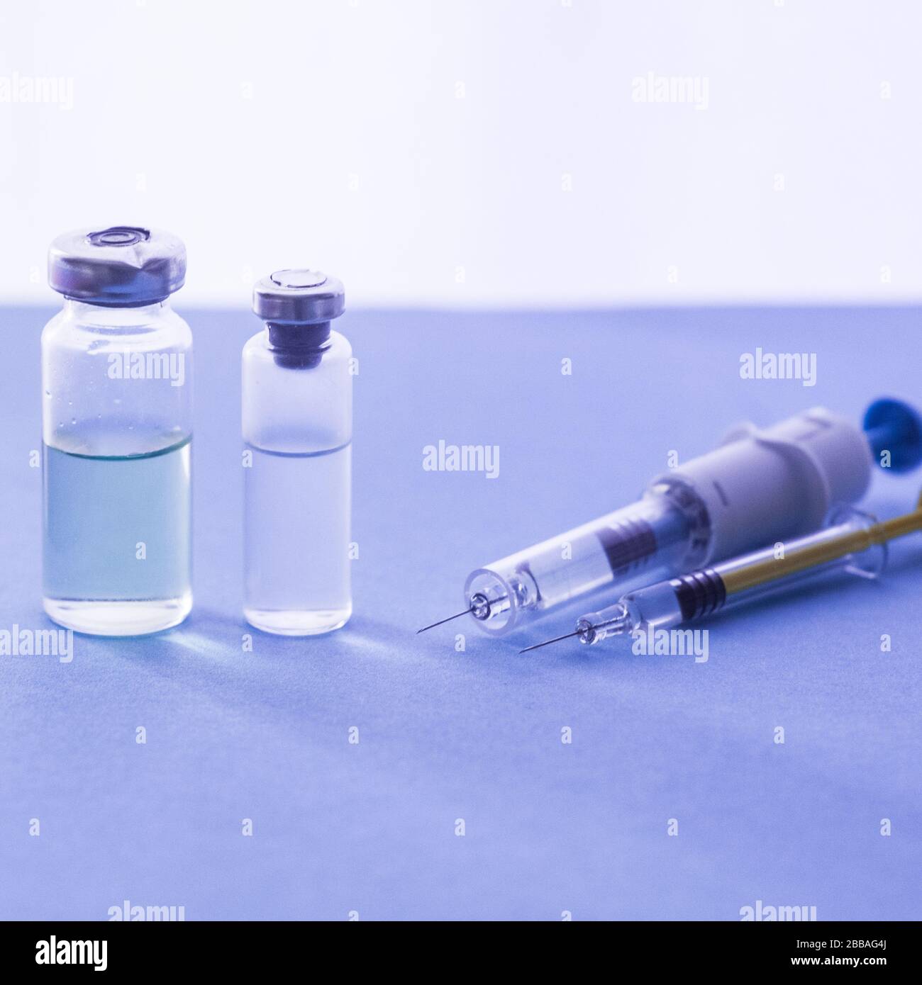 The covid-19 pandemic is concept. Vials of medication and syringe on a ...