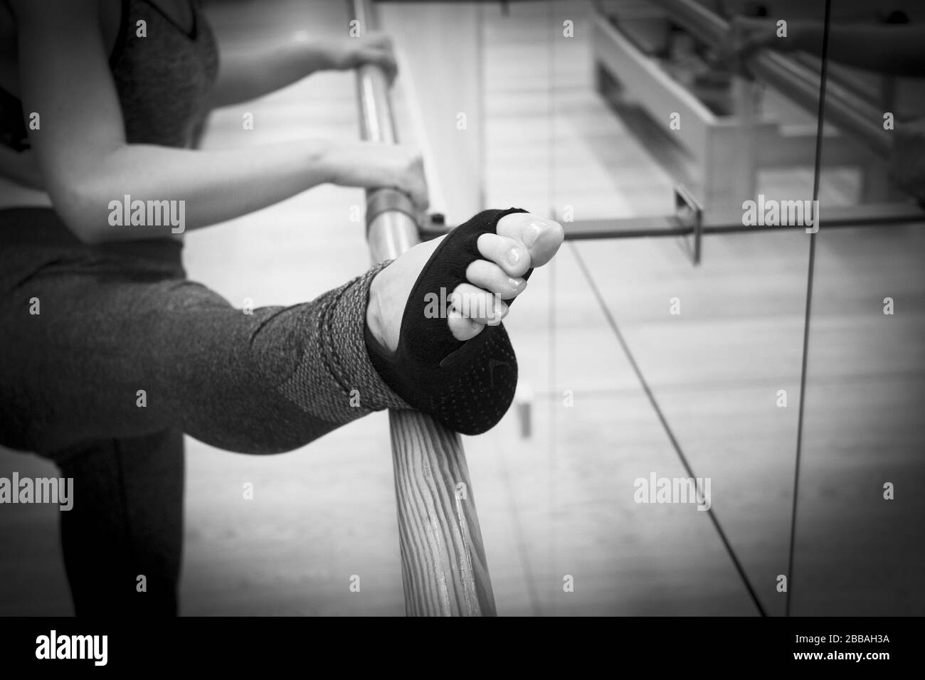 Female dancer doing leg stretches on the ballet barre Stock Photo - Alamy