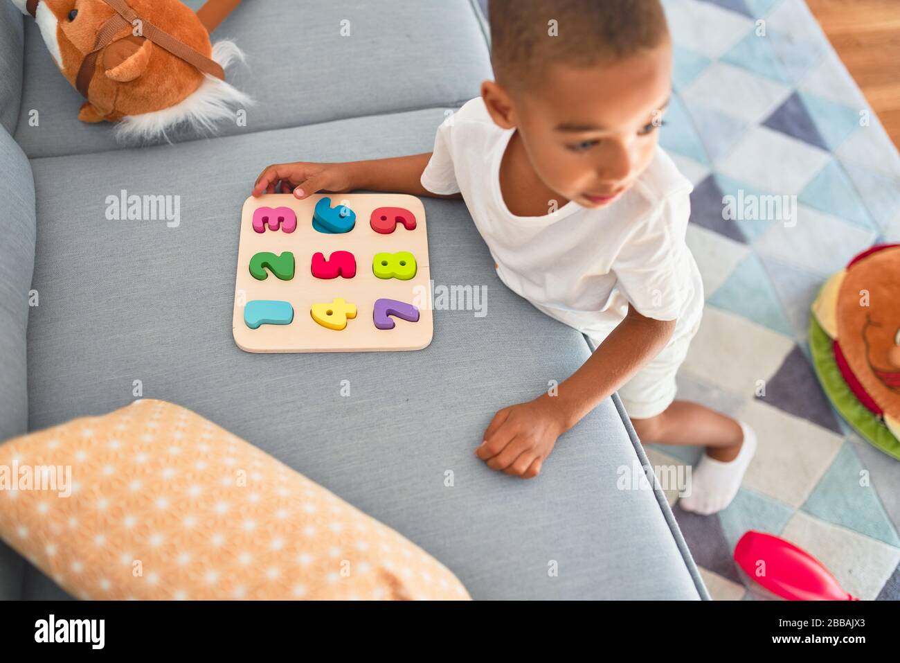Adorable african american toddler learning maths using mathematics game ...
