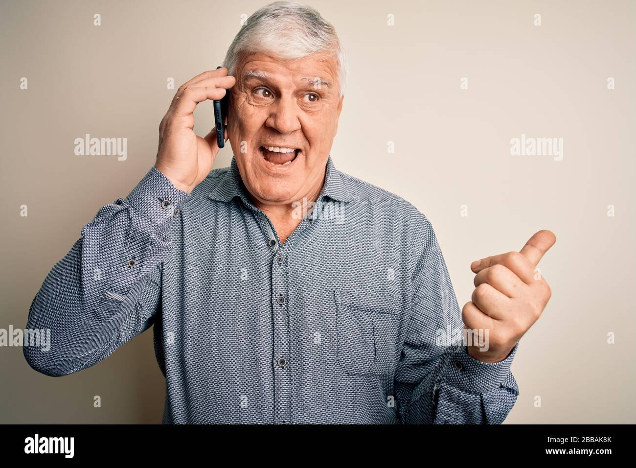 Senior hoary man having conversation talking on the smartphone over ...