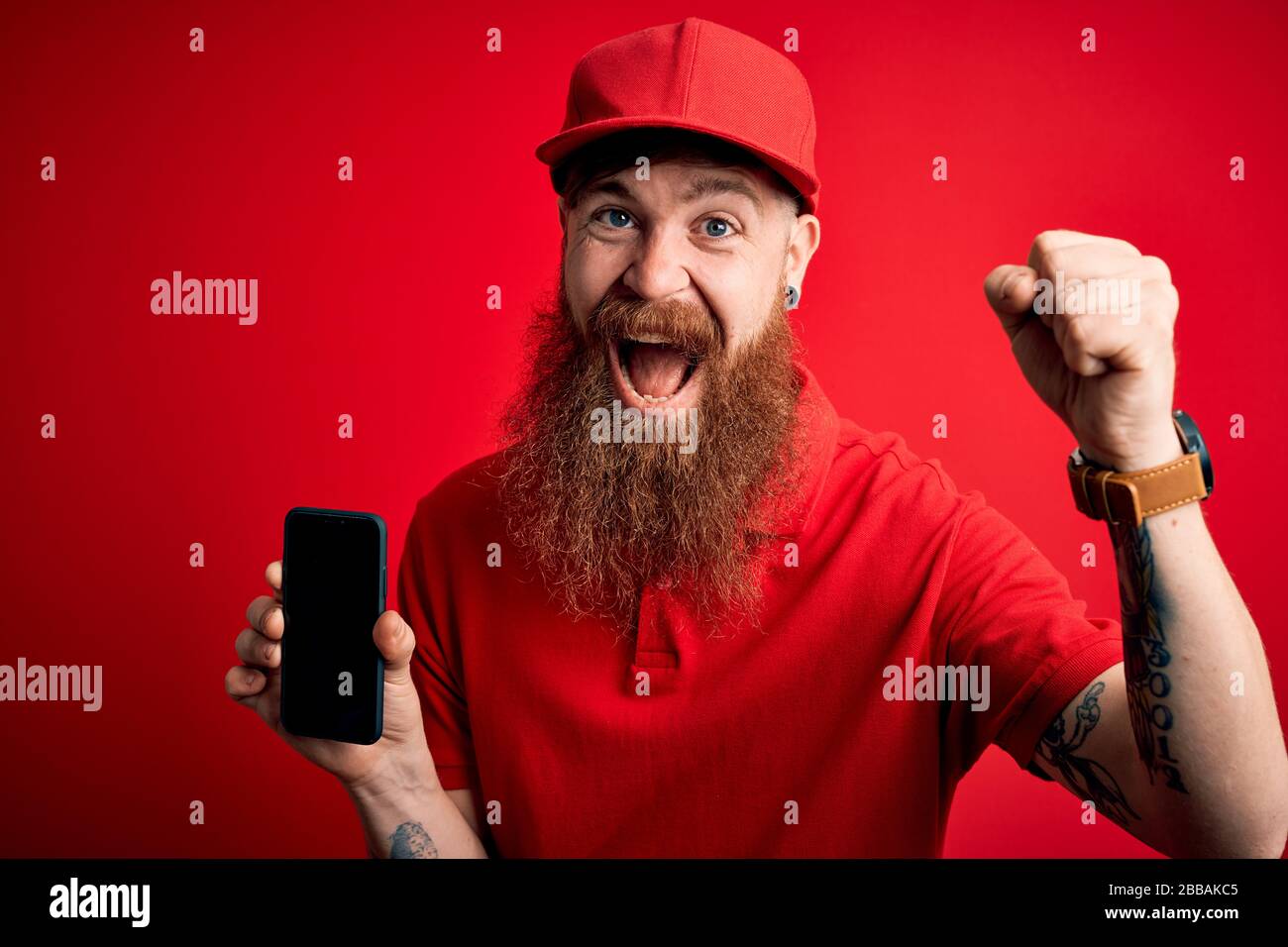 Redhead Irish Delivery Man With Beard Holding Smartphone Showing App On