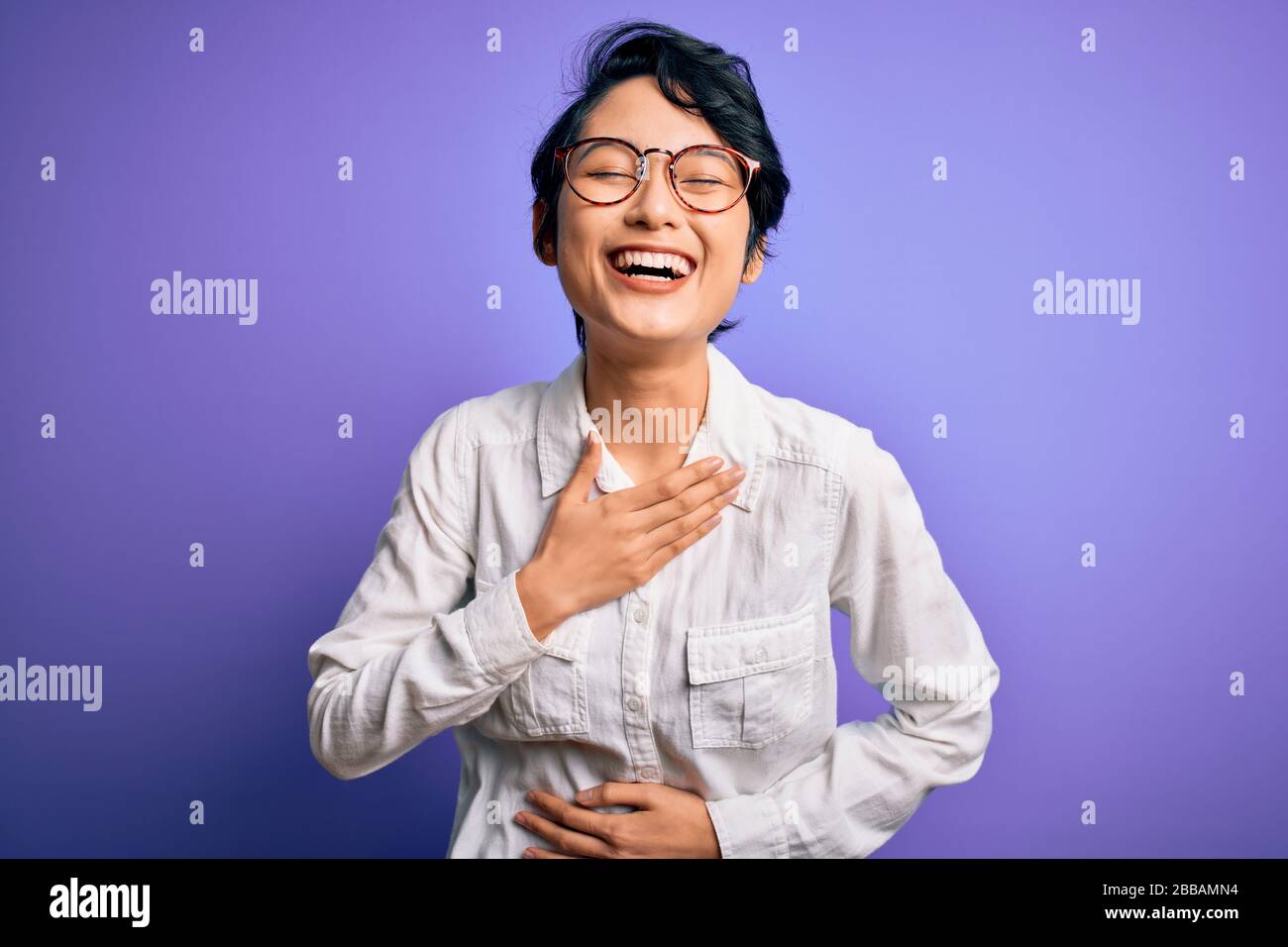 Young beautiful asian girl wearing casual shirt and glasses standing ...