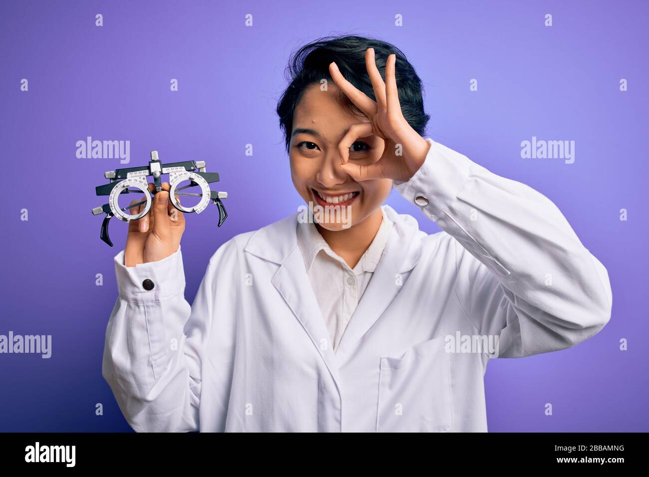 Beautiful asian optical girl wearing coat holding optometry glasses ...