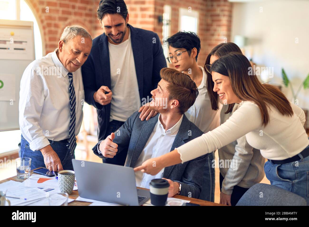 Group of business workers smiling happy and confident. One of them ...