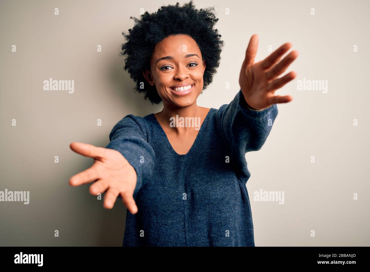 Young beautiful African American afro woman with curly hair wearing ...