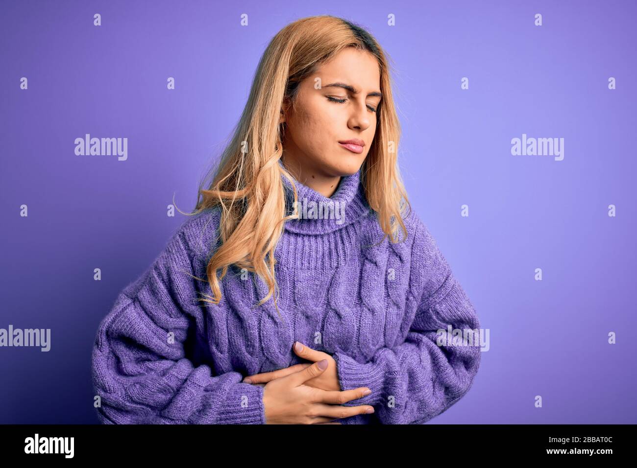 Young beautiful blonde woman wearing casual turtleneck sweater over ...