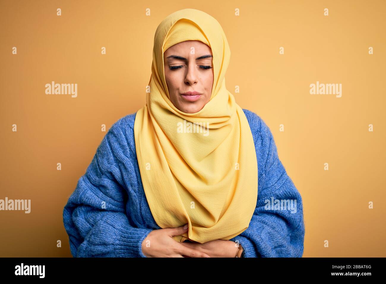 Young beautiful brunette muslim woman wearing arab hijab over isolated ...