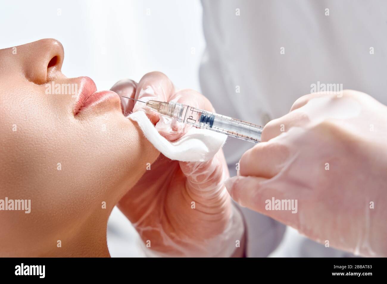 lip shape correction procedure in a cosmetology salon. The specialist ...