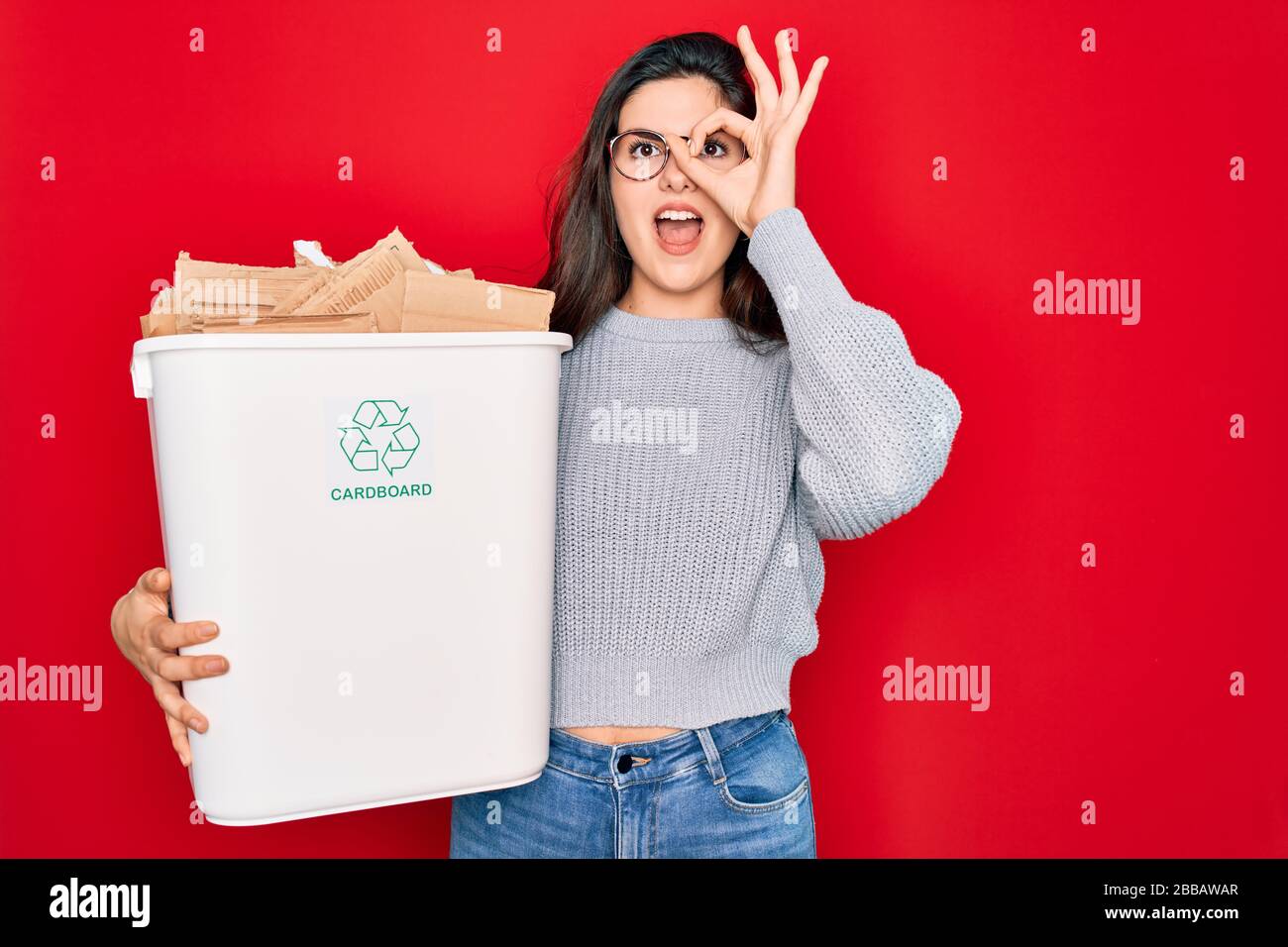 Young beautiful woman holding recycle cardboard containter recycling ...