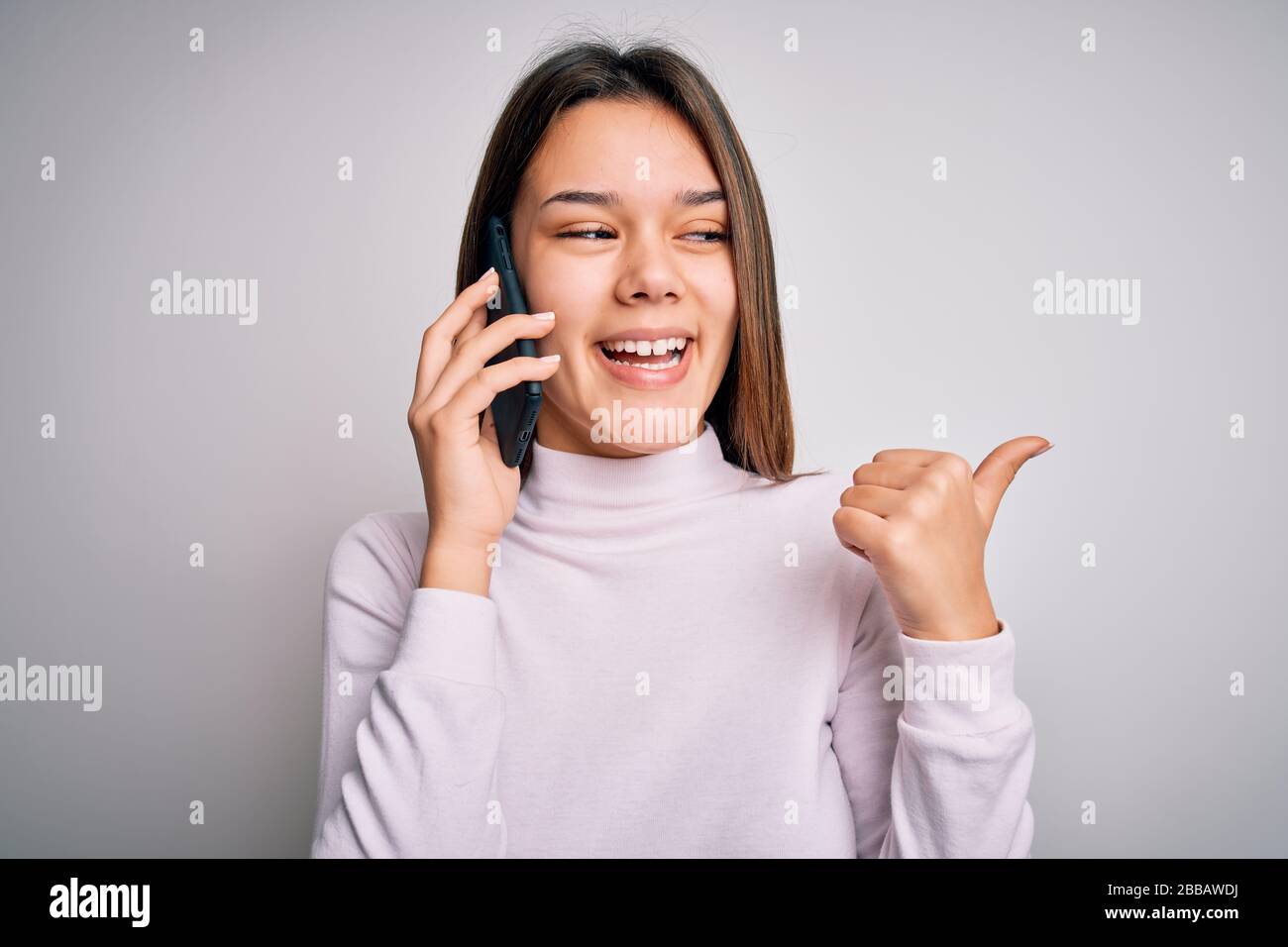 Beautiful brunette girl having conversation talking on the smartphone ...