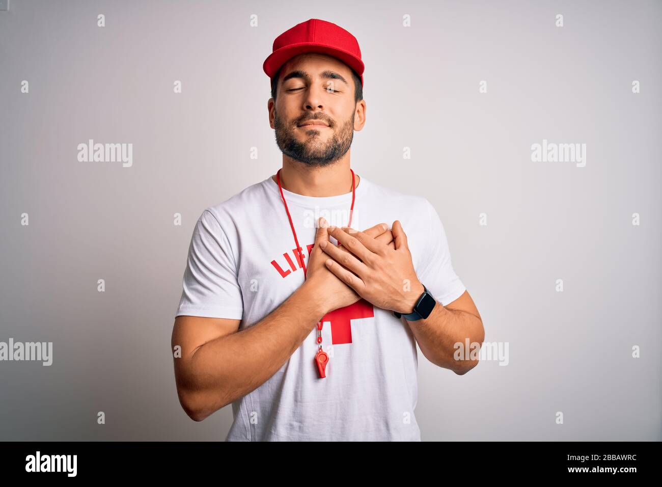 Young handsome lifeguard man with beard wearing t-shirt with red cross ...