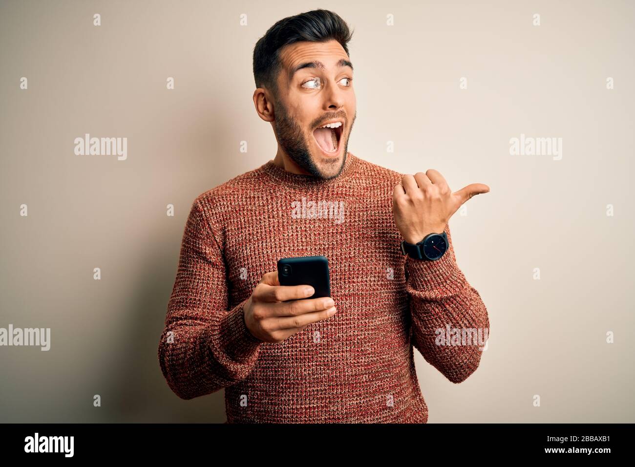 Young handsome man having conversation using smartphone over white ...