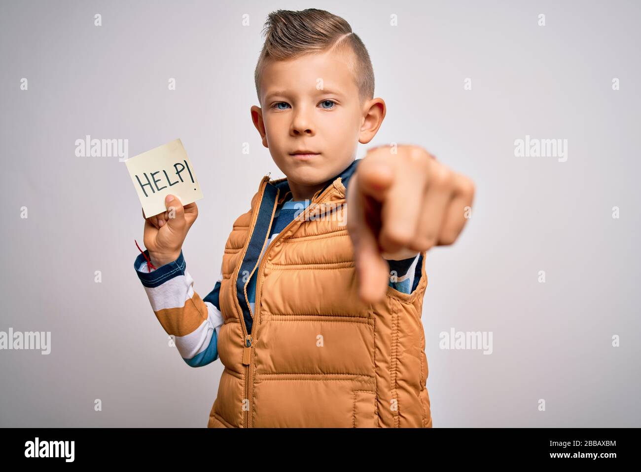 Young little caucasian kid asking for help on a paper note as violence ...