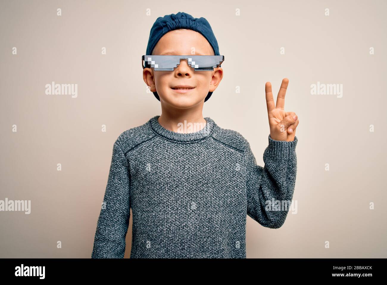Young little caucasian kid wearing internet meme thug life glasses over ...