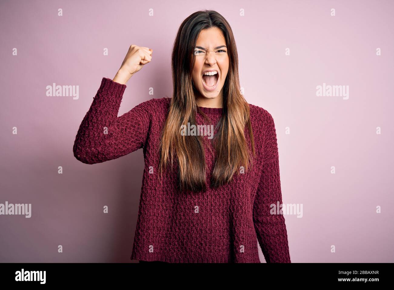 Young beautiful girl wearing casual sweater over isolated pink ...