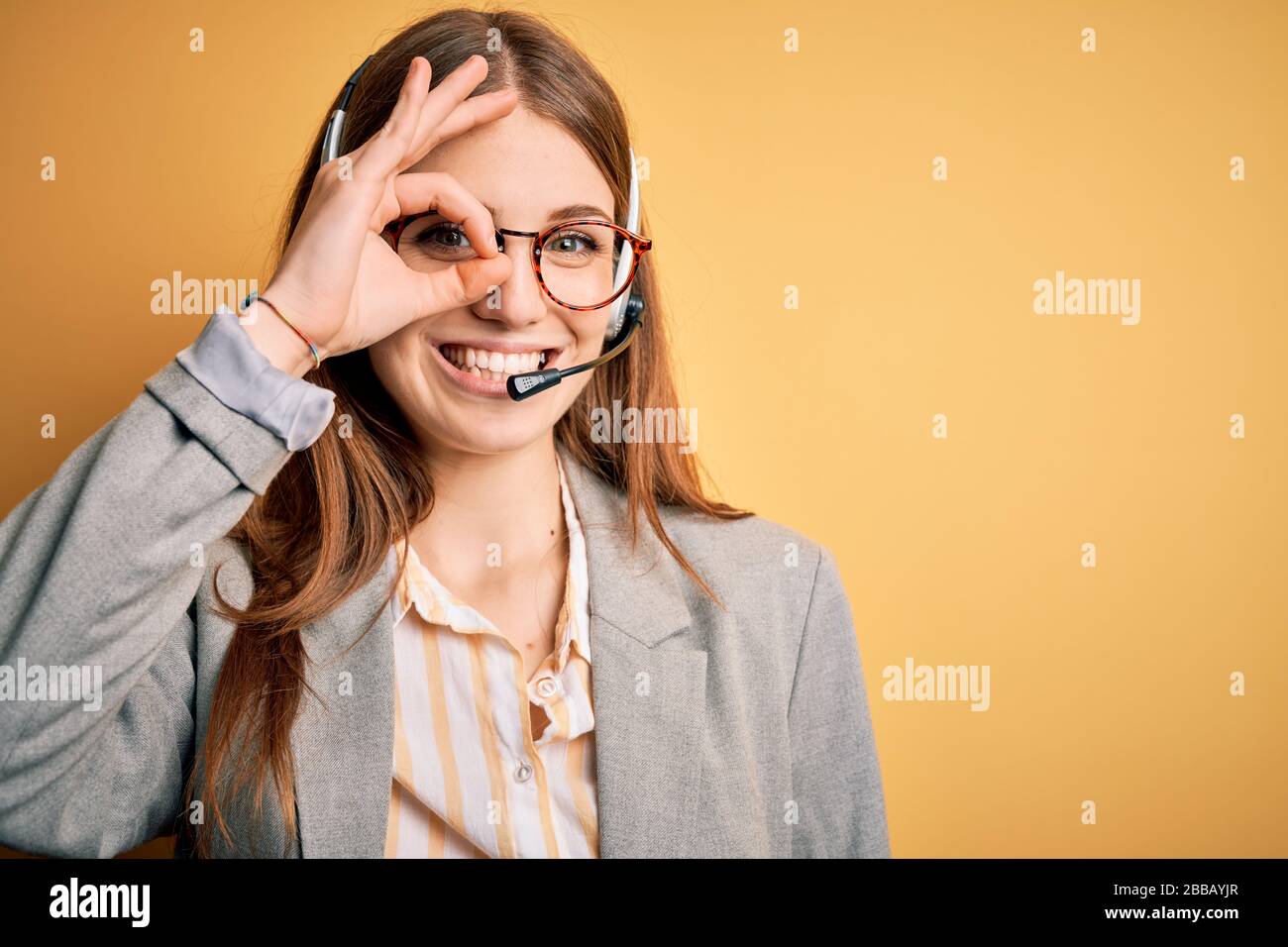 Young redhead call center agent woman overworked wearing glasses using ...