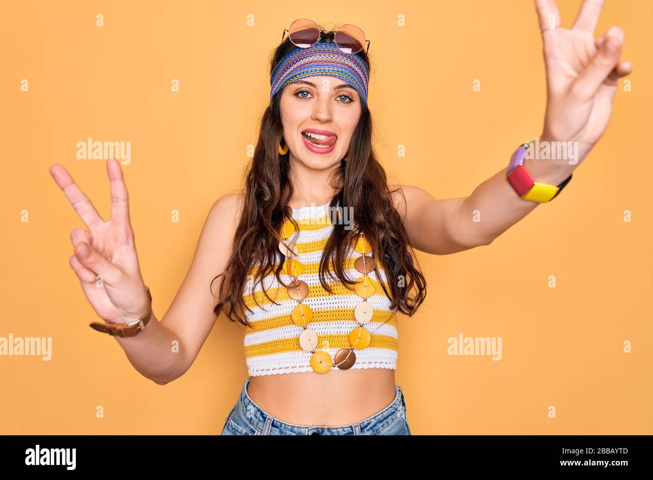 Young beautiful hippie woman with blue eyes wearing accesories and ...