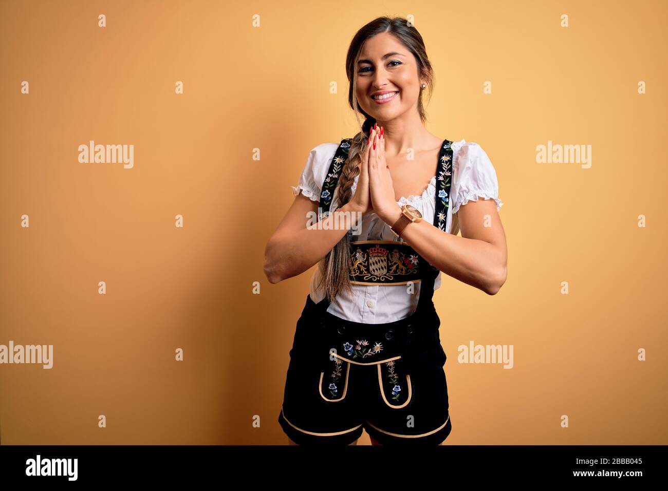 Young beautiful brunette german woman celebrating Octoberfest wearing ...